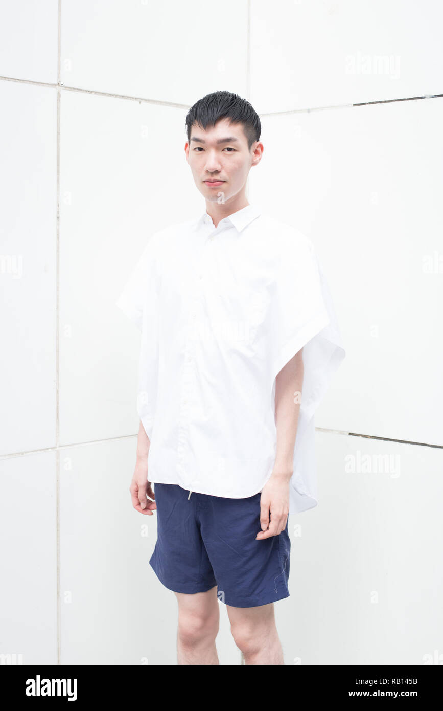 Asian male model poses for pictures on the street Stock Photo - Alamy