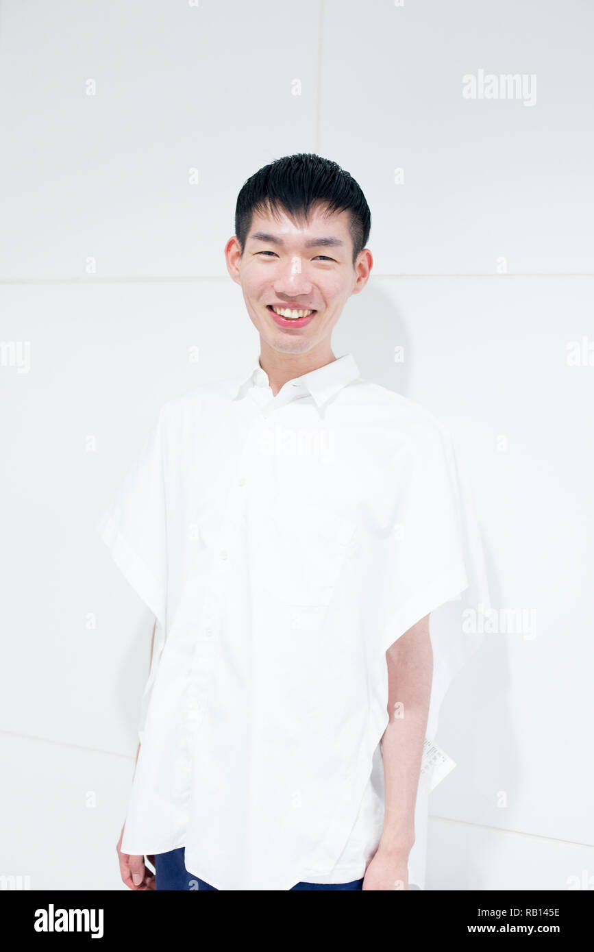 Asian male model poses for pictures on the street Stock Photo - Alamy