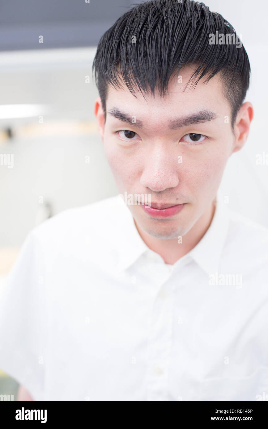 Asian male model poses for pictures on the street Stock Photo - Alamy