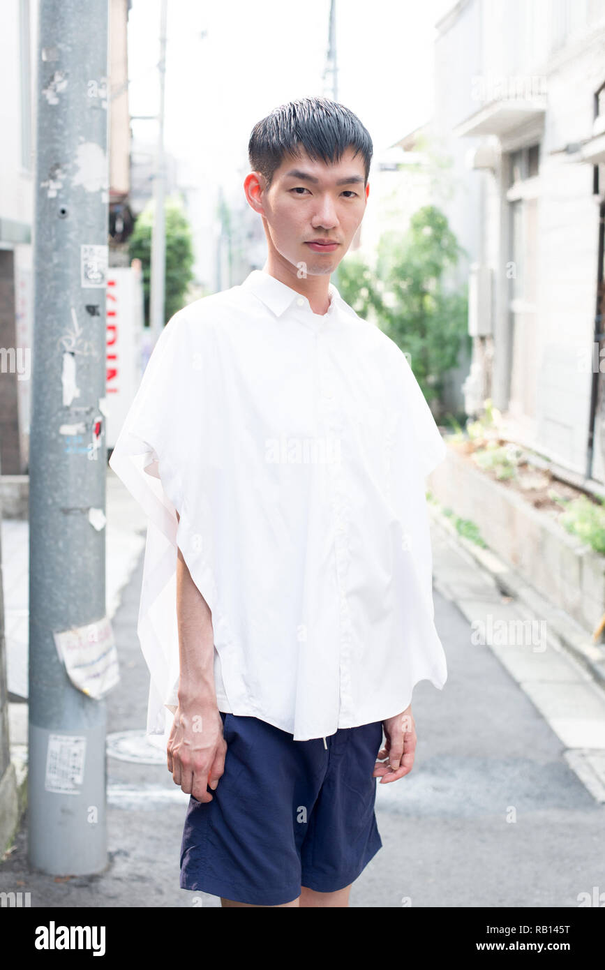 Asian male model poses for pictures on the street Stock Photo - Alamy