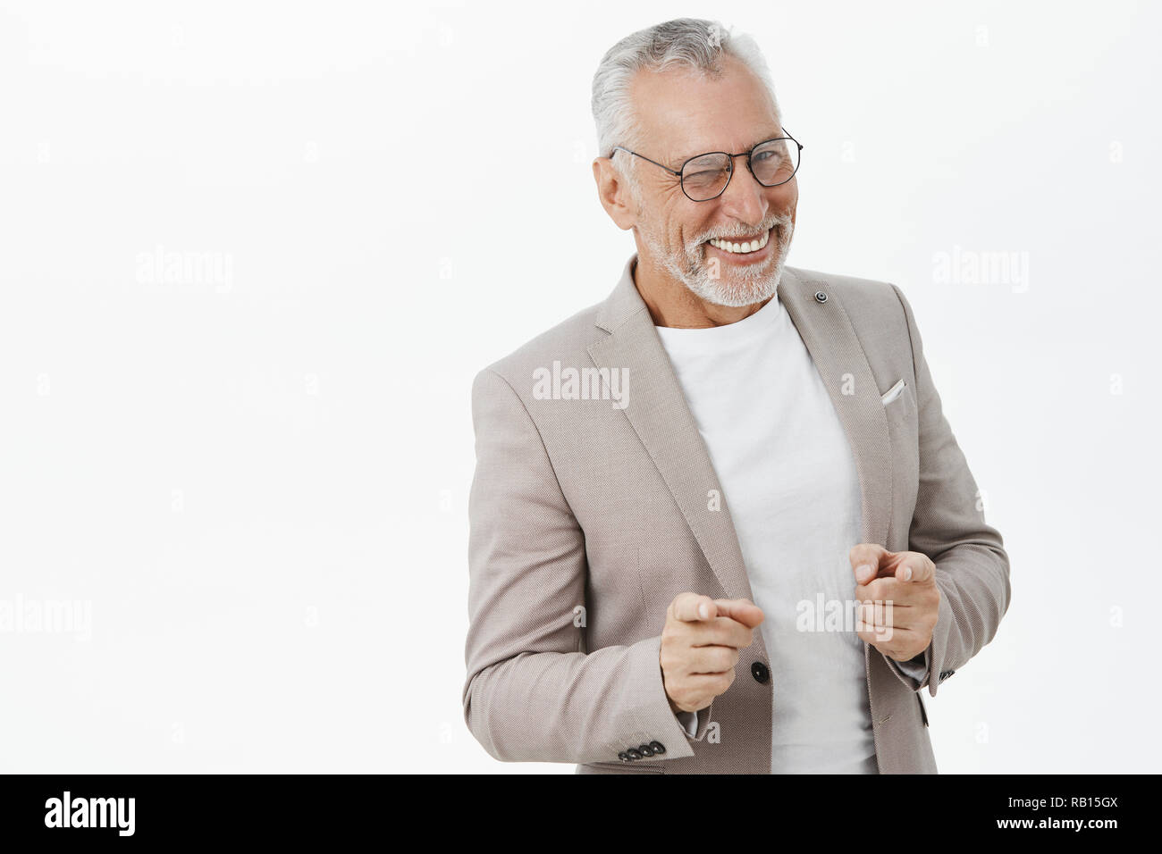 Mature winking man pointing hi-res stock photography and images - Alamy