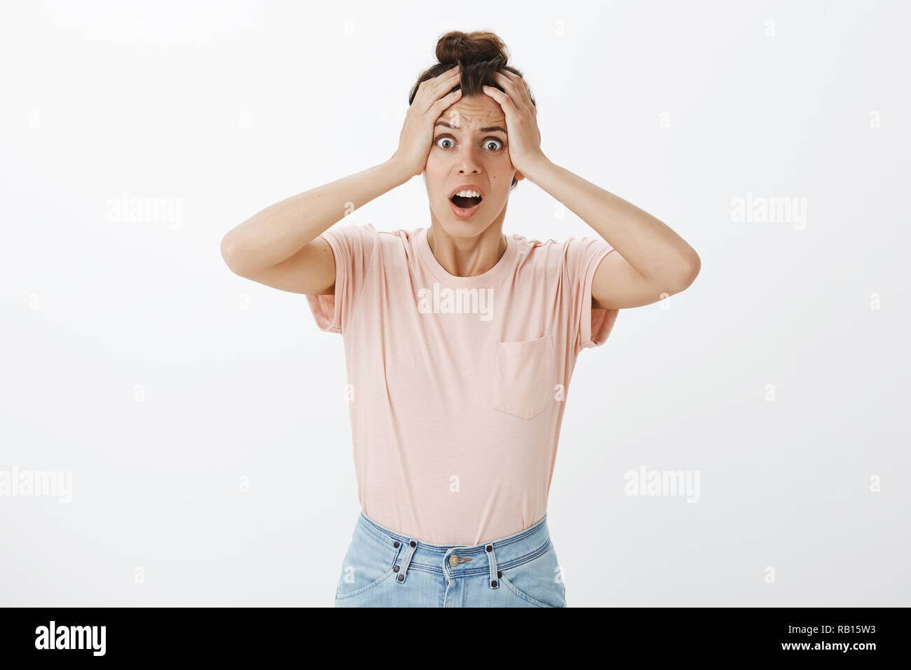 Studio shot of panicking woman realising forgot to send important email ...