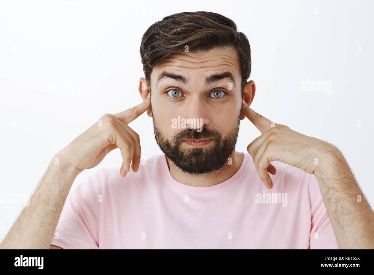 Holding ears male noise hi-res stock photography and images - Alamy