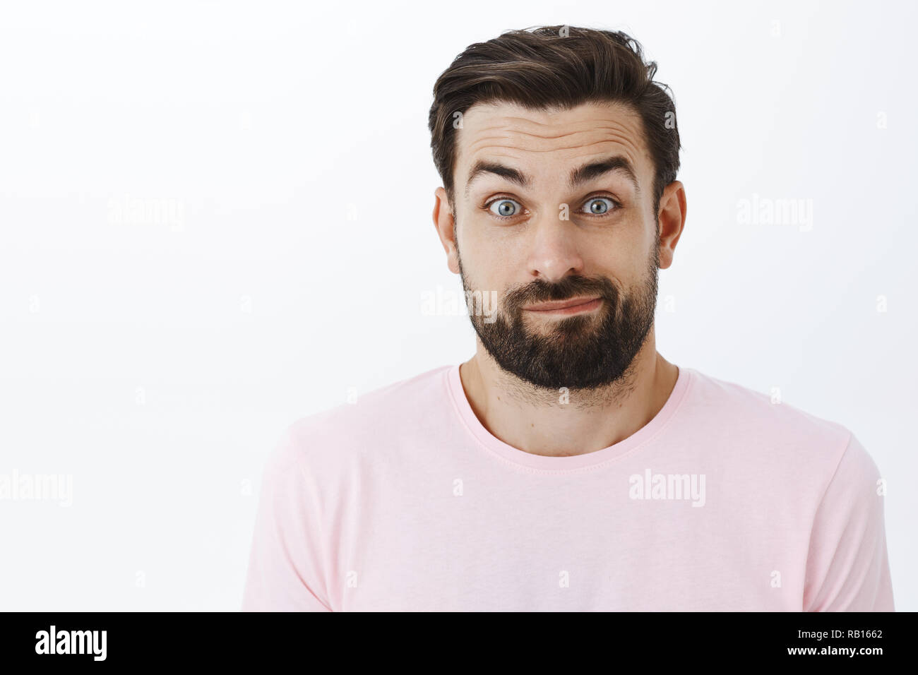 Portrait of a clueless businessman posing against sharks circling a ...