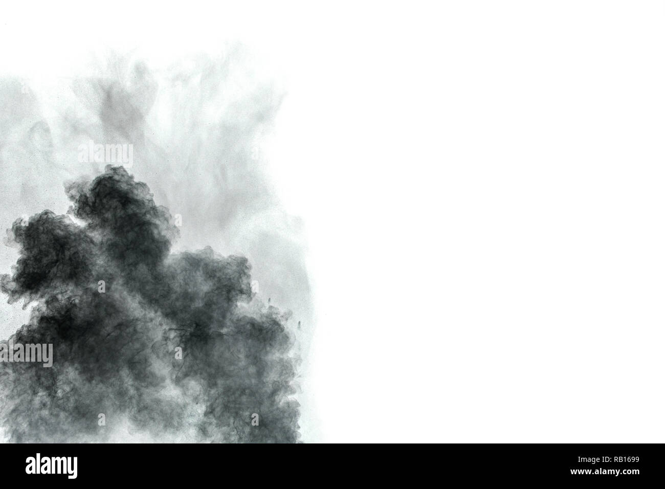 Closeup of black dust particles explode isolated on white background ...