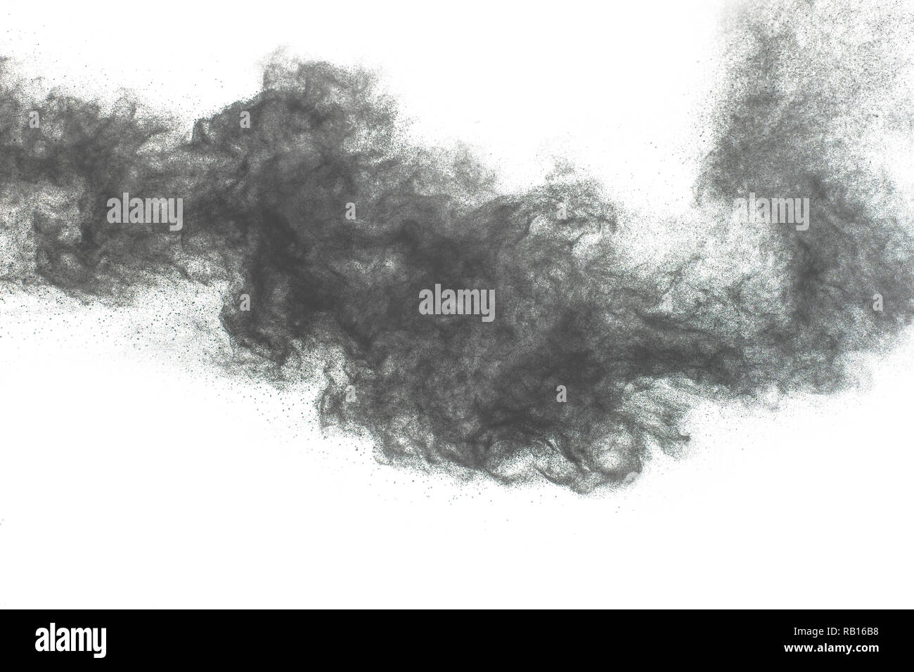 Closeup of black dust particles explode isolated on white background ...