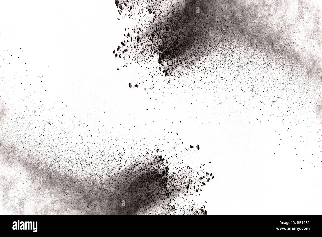 Closeup of black dust particles explode isolated on white background ...