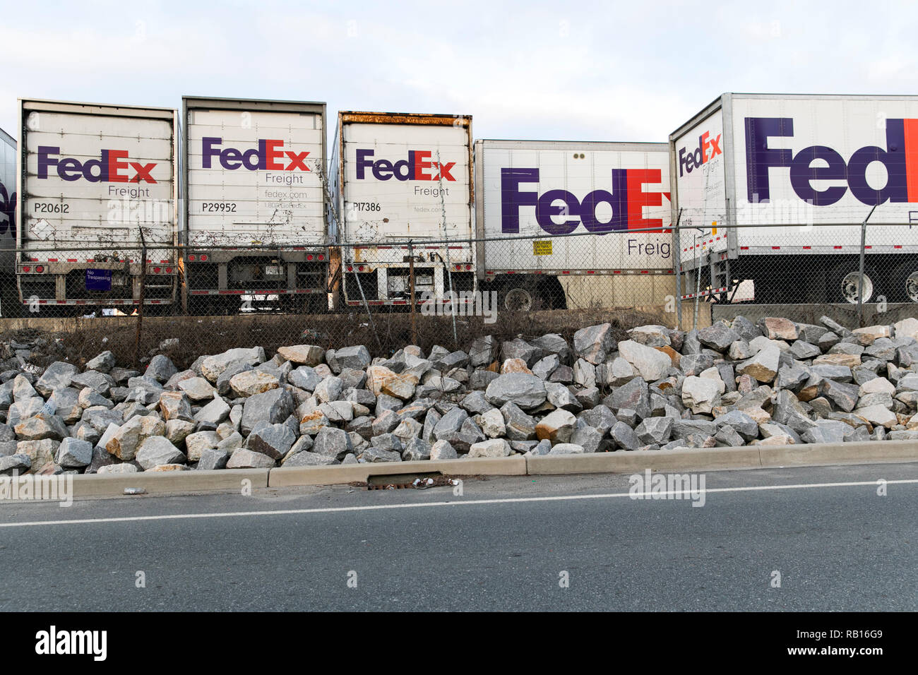 Logo signs on a row of FedEx Freight trailers at a distribution center ...