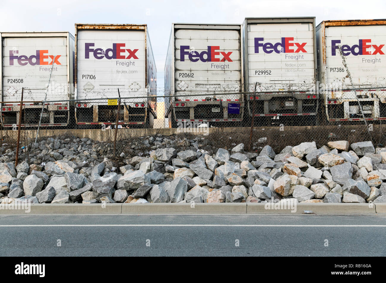 Logo signs on a row of FedEx Freight trailers at a distribution center ...