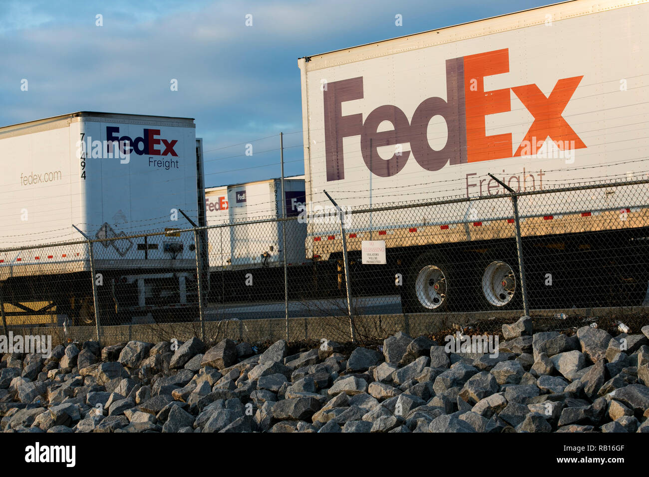 Logo signs on a row of FedEx Freight trailers at a distribution center ...