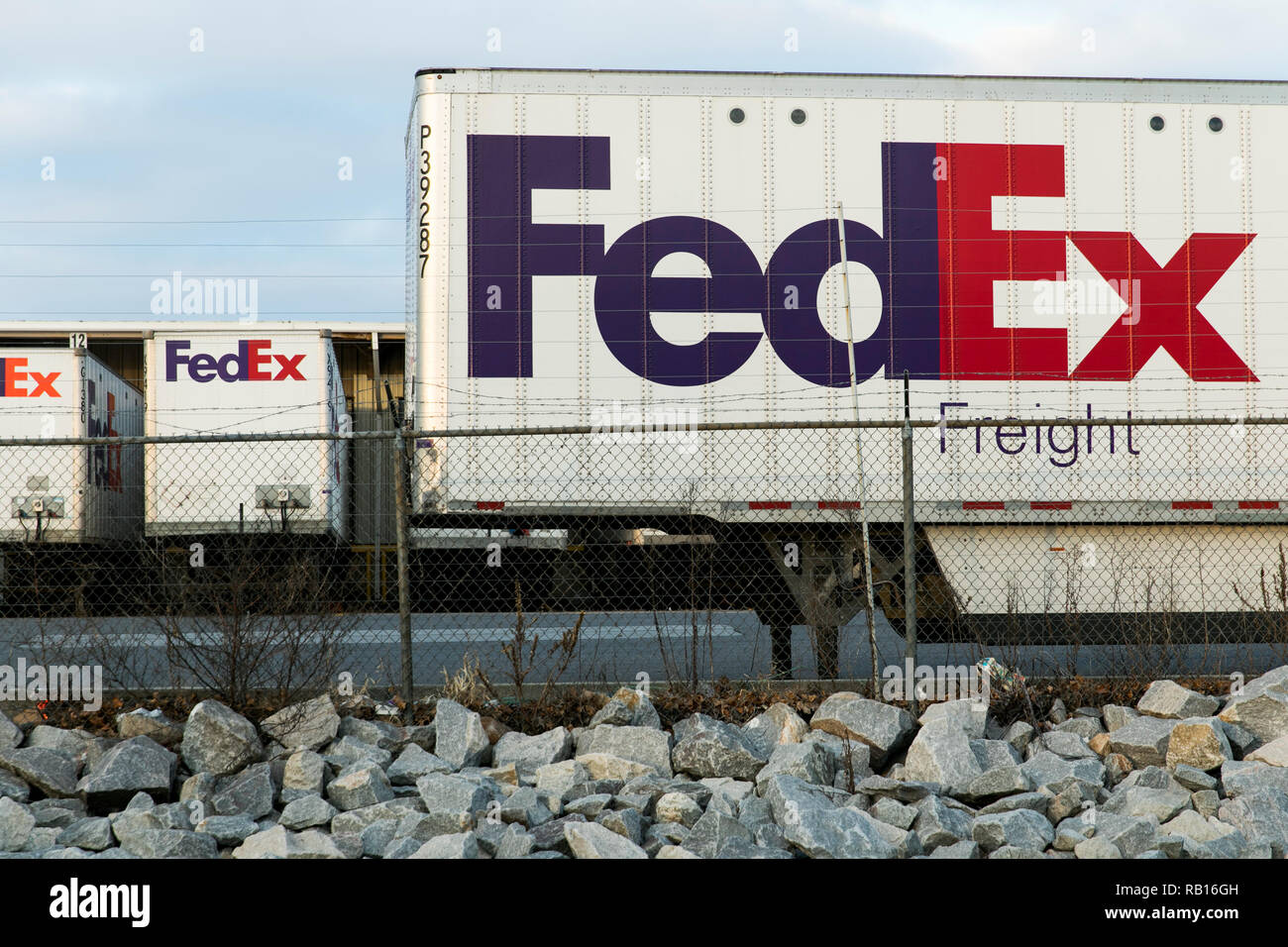 Logo signs on a row of FedEx Freight trailers at a distribution center ...
