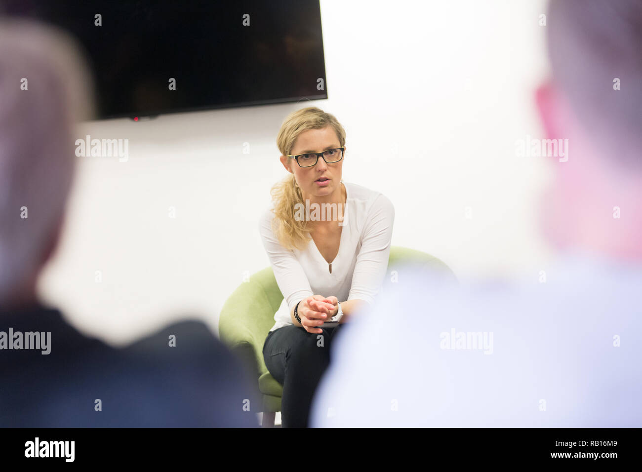 Female candidate presenting her CV in front of business job recuters ...