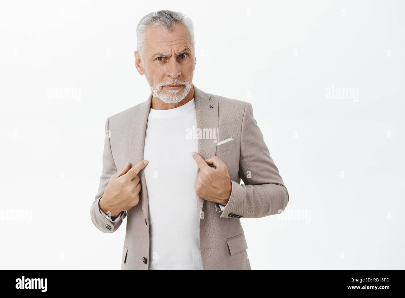 Portrait of senior man being accused in commiting crime standing ...