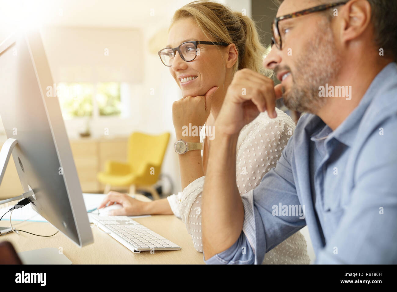 Business people working together on desktop computer Stock Photo - Alamy