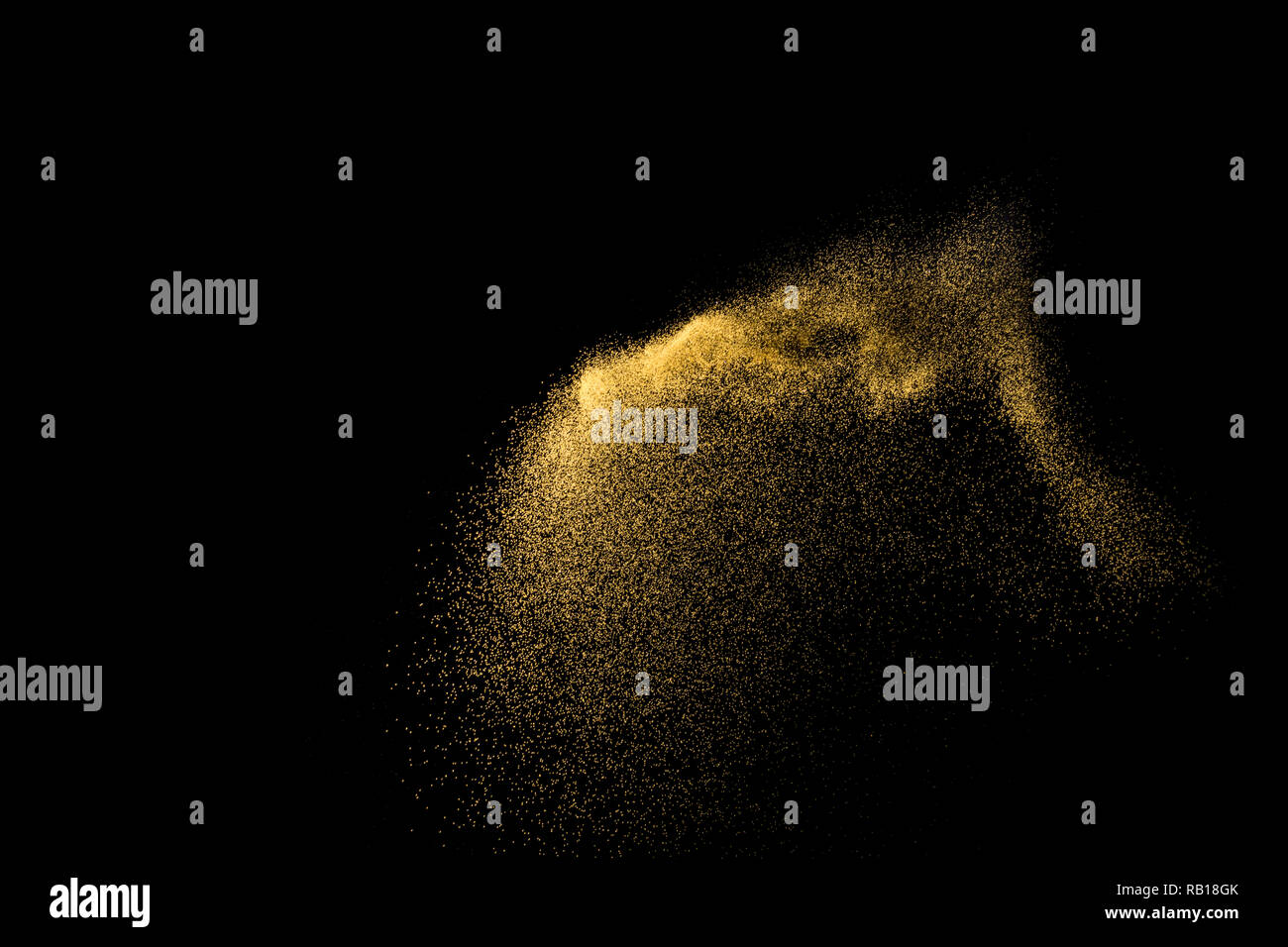 Golden sand explosion isolated on black background. Abstract sand cloud ...