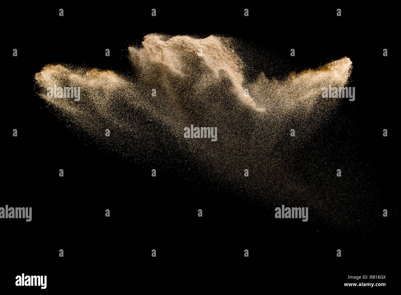 Golden sand explosion isolated on black background. Abstract sand cloud ...