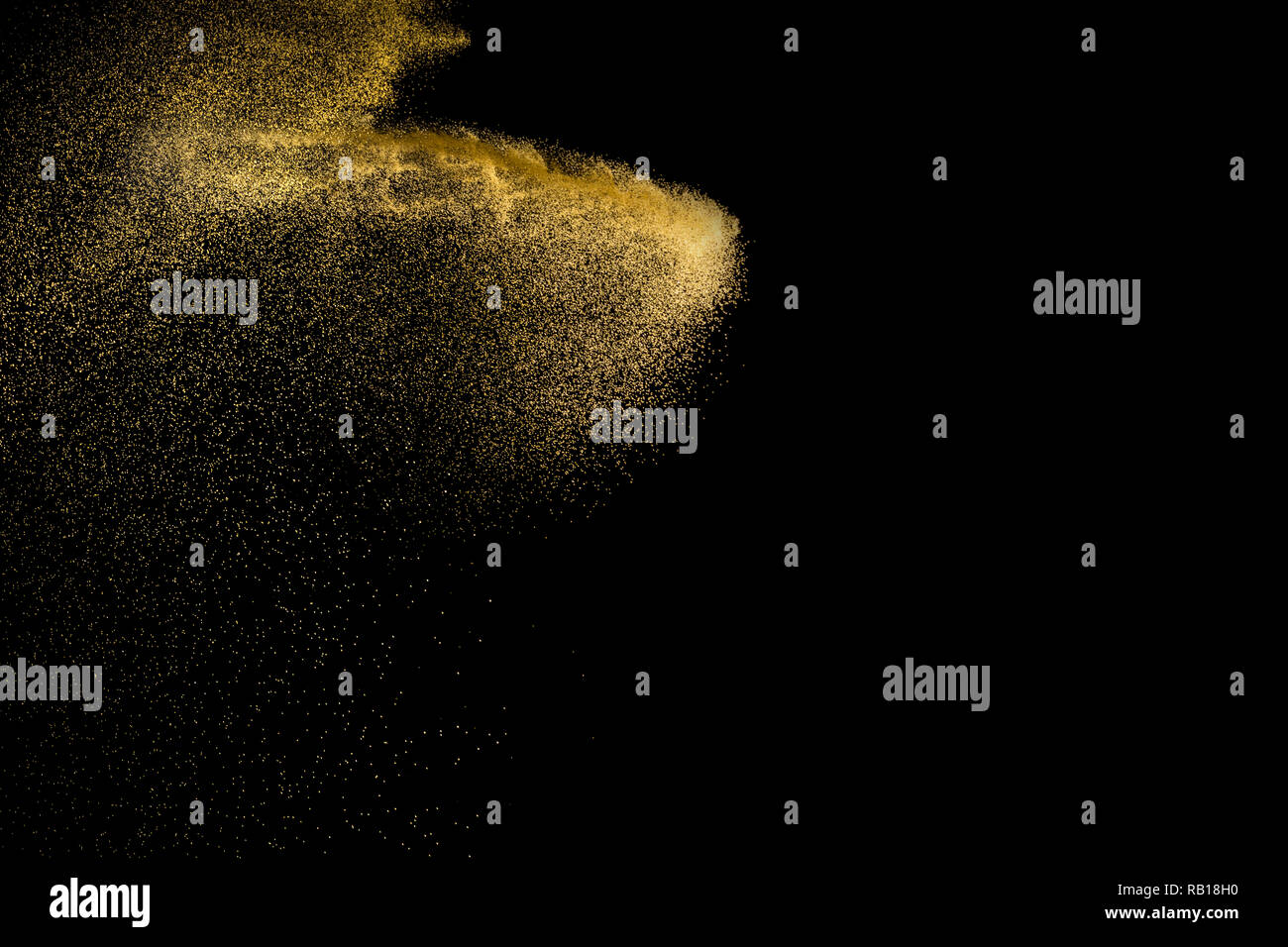 Golden sand explosion isolated on black background. Abstract sand cloud ...