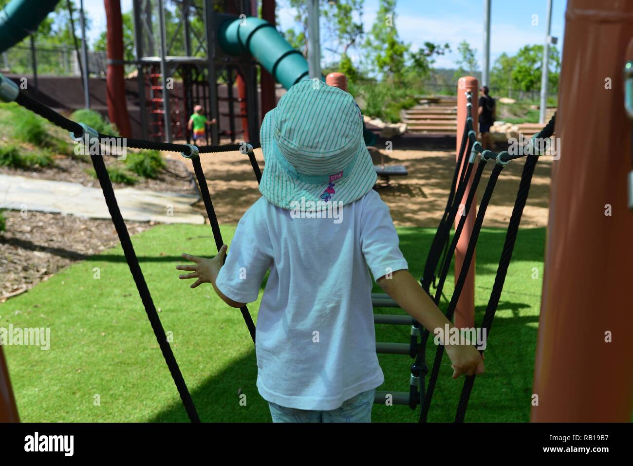A young girl plays on a new playground, Wadda Mooli Park Playground ...