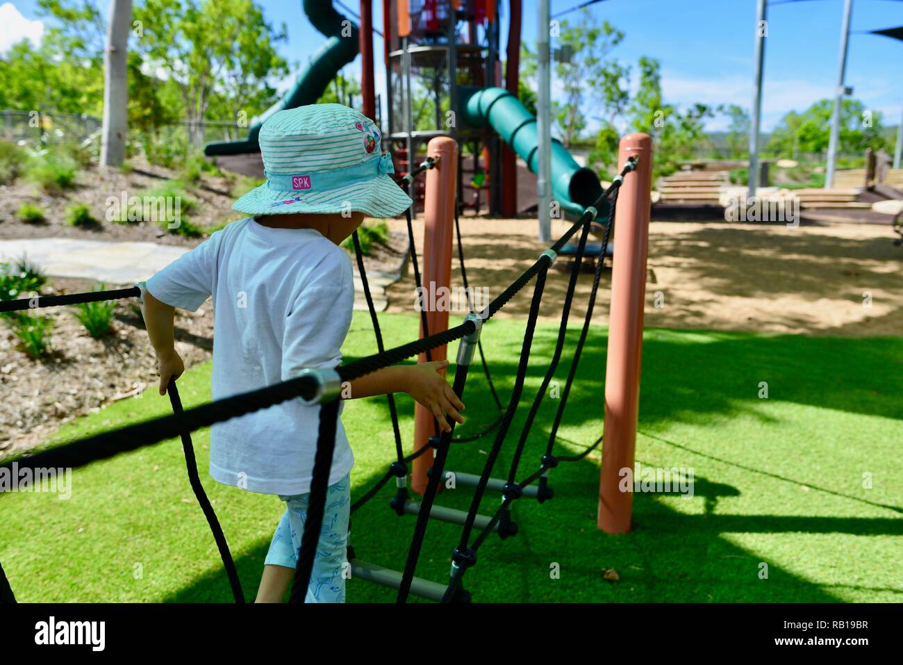 A young girl plays on a new playground, Wadda Mooli Park Playground ...