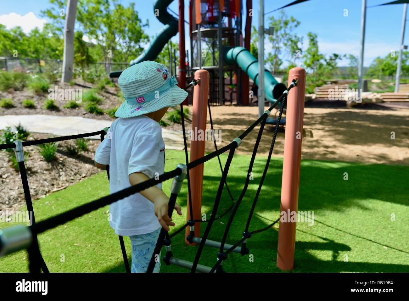 A young girl plays on a new playground, Wadda Mooli Park Playground ...