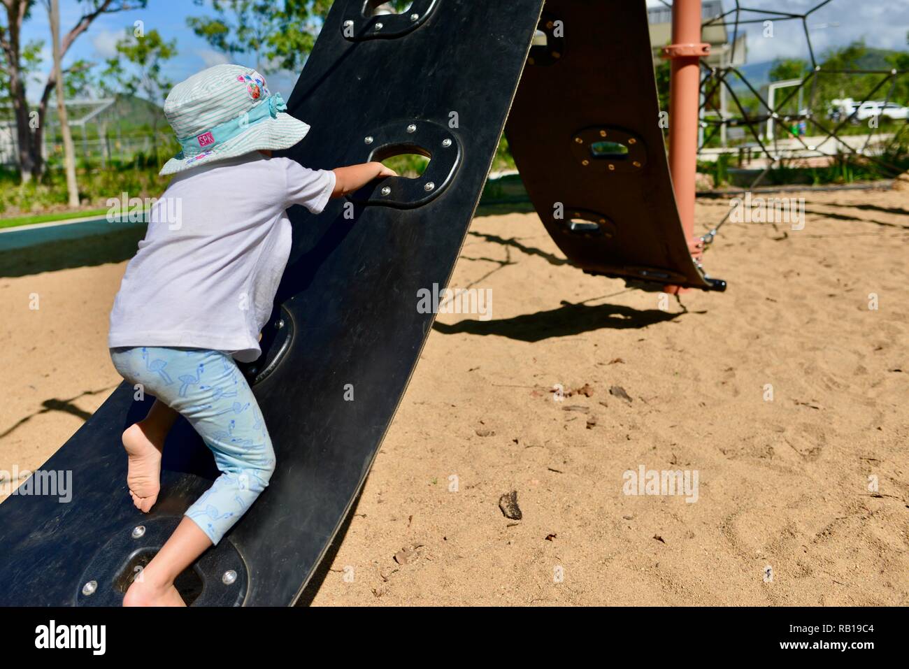 A young girl plays on a new playground, Wadda Mooli Park Playground ...