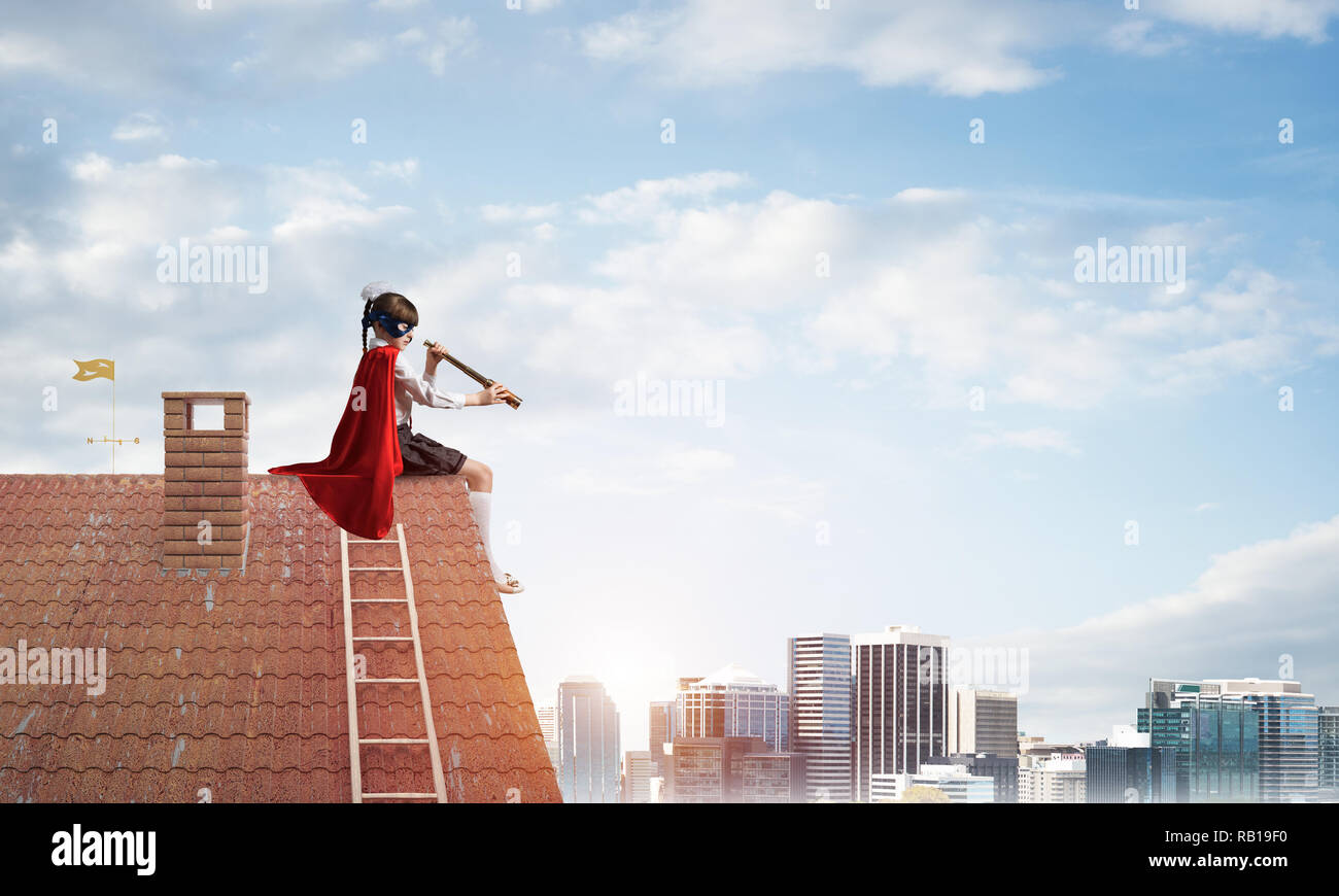 Girl power concept with cute kid guardian against cityscape background ...