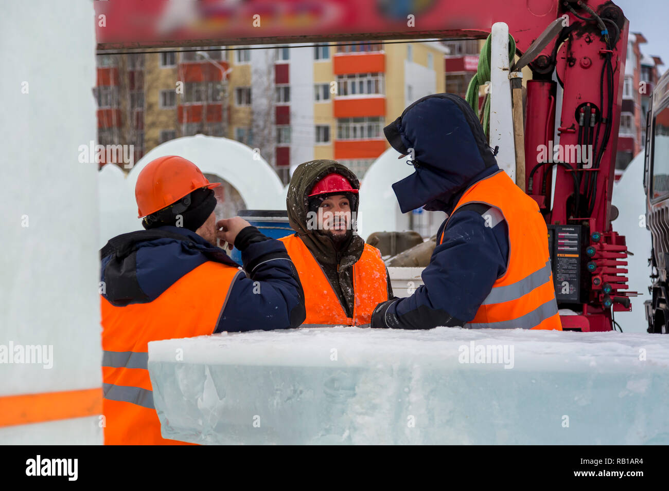 Workers at the construction site of the ice town for a conversation ...