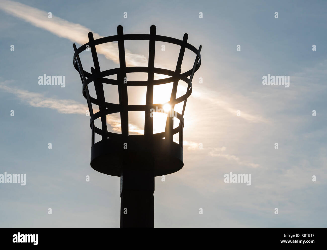 Sun shining through a beacon brazier by the coast in the UK Stock Photo ...