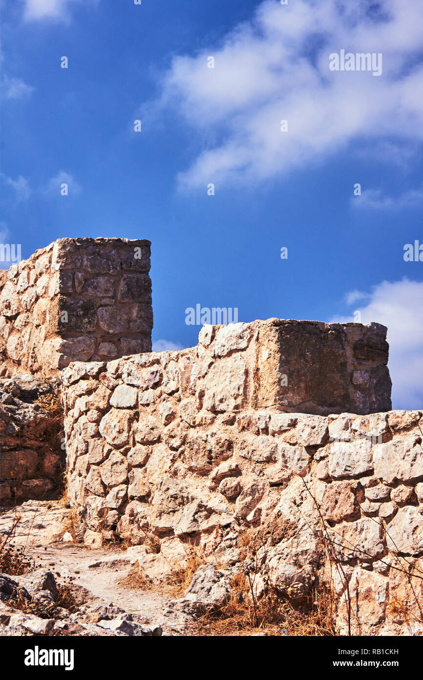 Crash stone ramparts against the white clouds and blue sky on the ...