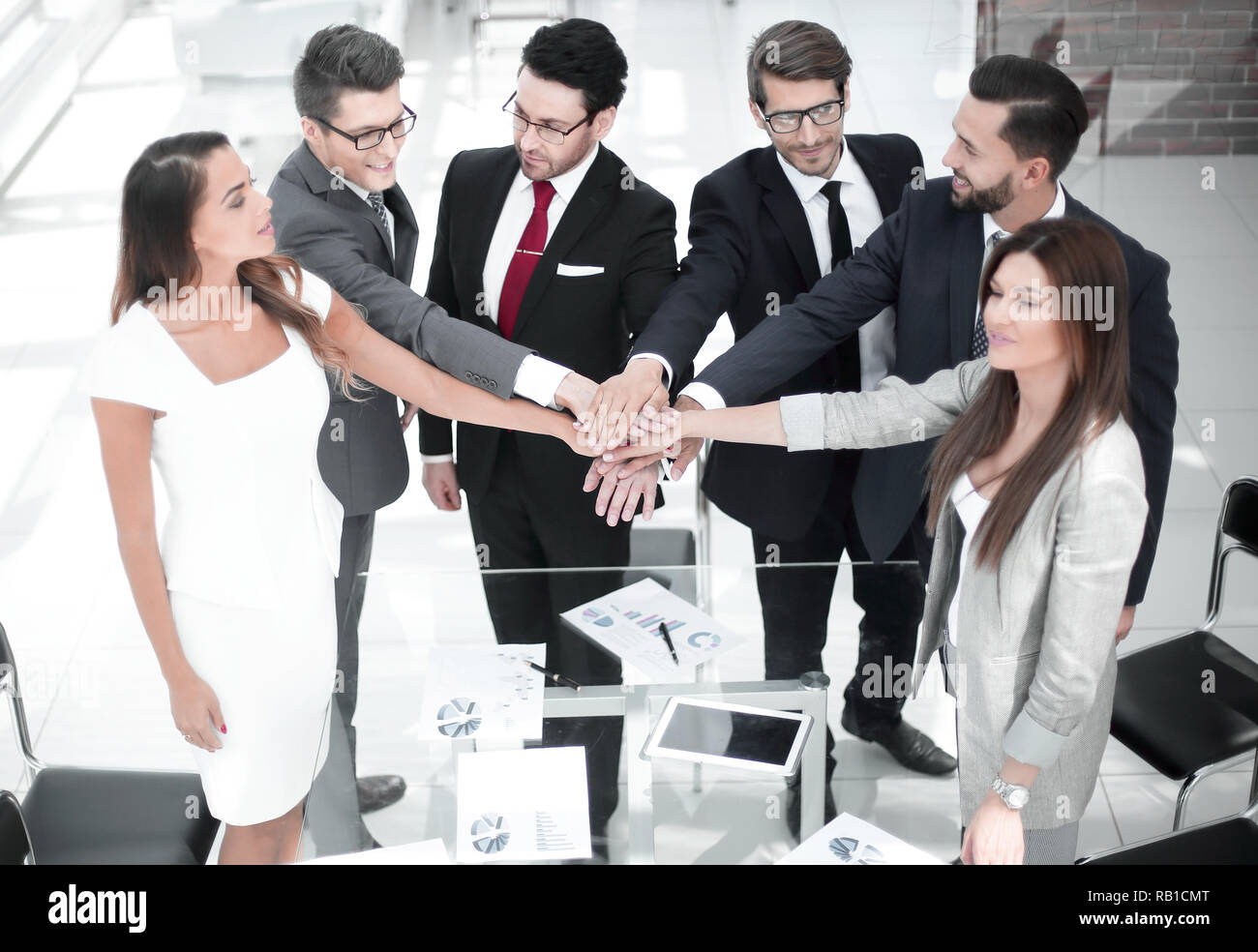 group of young business people showing their unity Stock Photo - Alamy