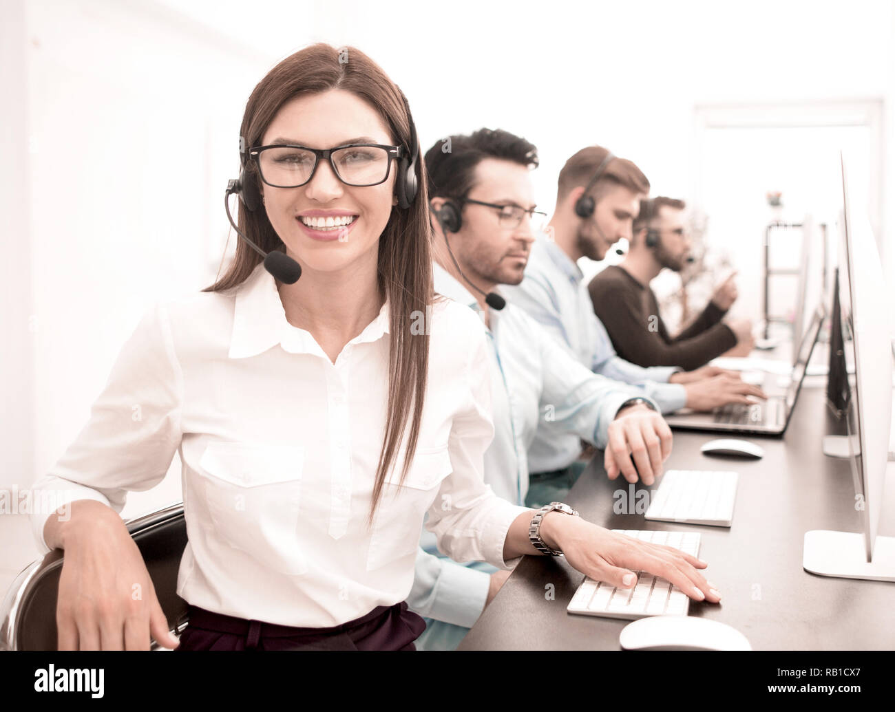smiling call center employee works in a modern office Stock Photo - Alamy