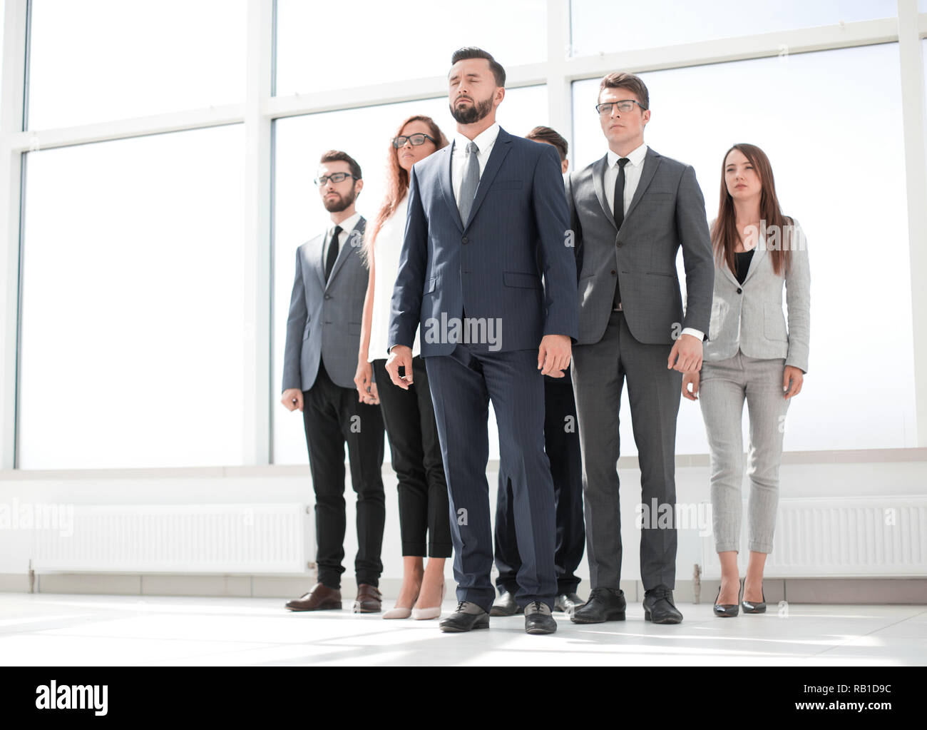 business team standing in new office Stock Photo - Alamy