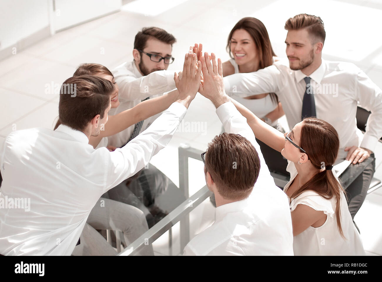 successful business team giving each other a high five Stock Photo - Alamy