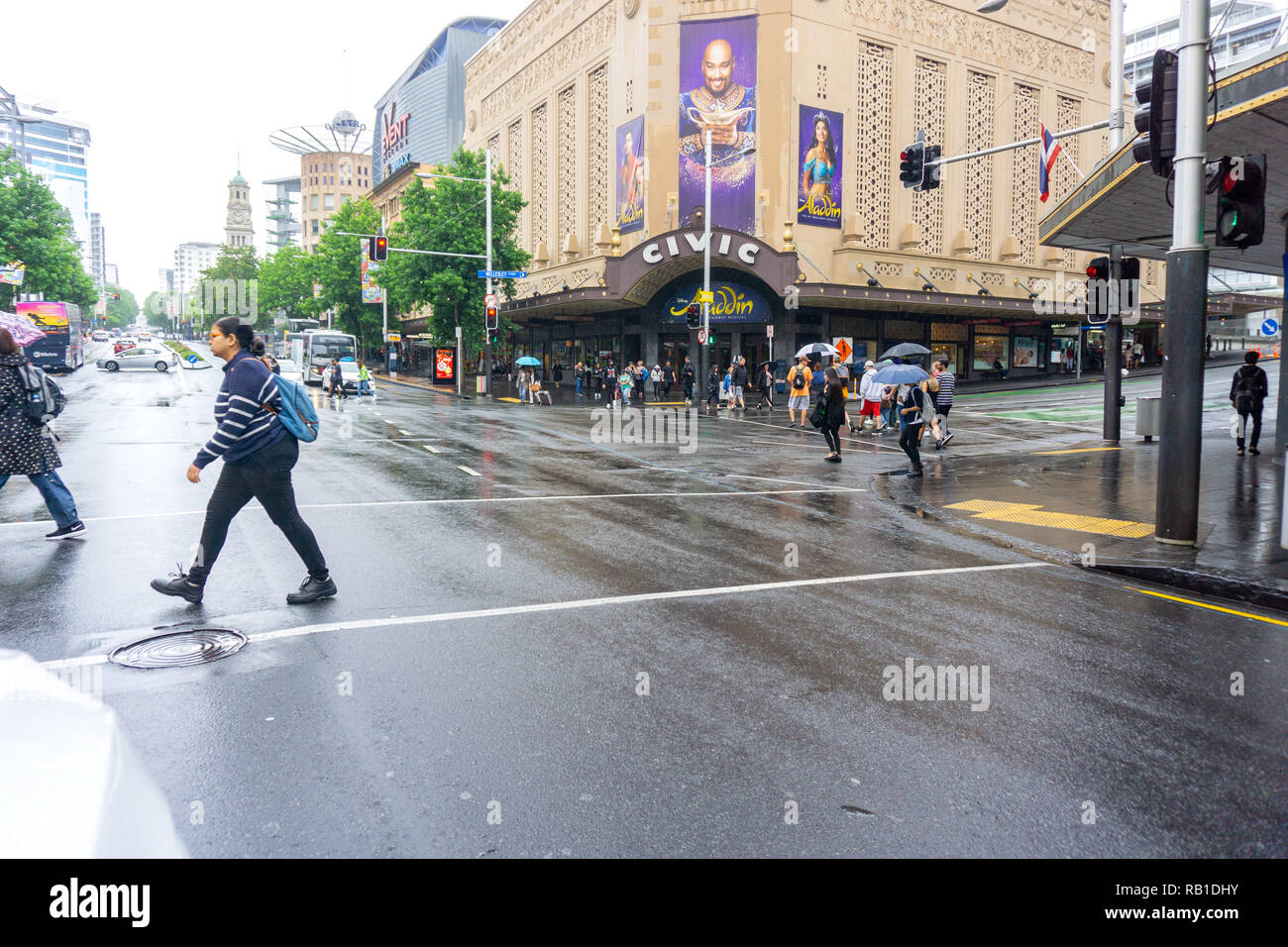 AUCKLAND NEW ZEALAND - DECEMBER 23 2018; People cross Queen Street and ...