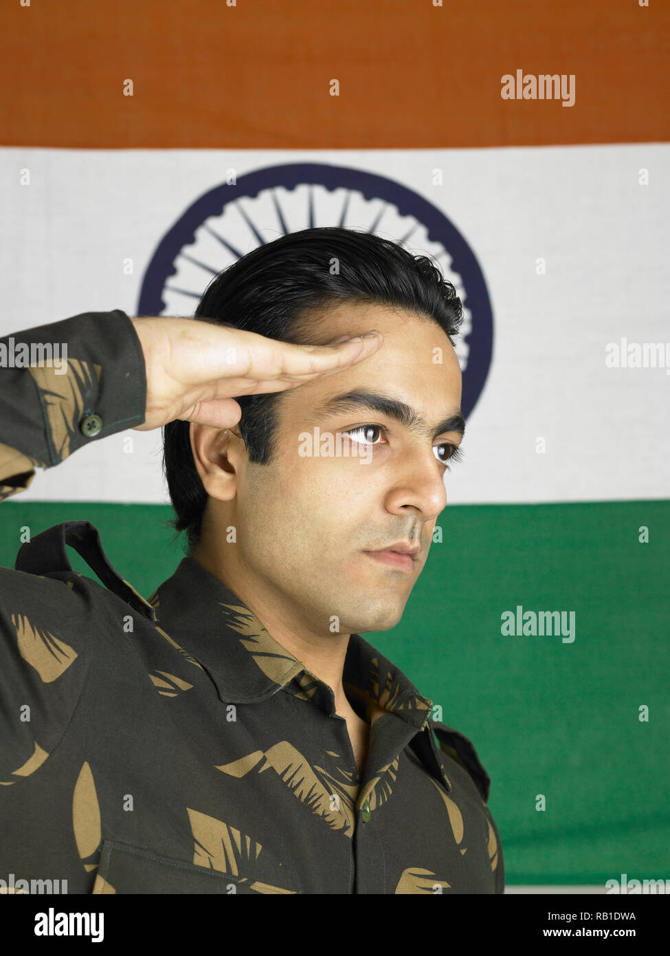 PORTRAIT OF INDIAN SOLDIER DRESSED IN UNIFORM SALUTING THE INDIAN ...