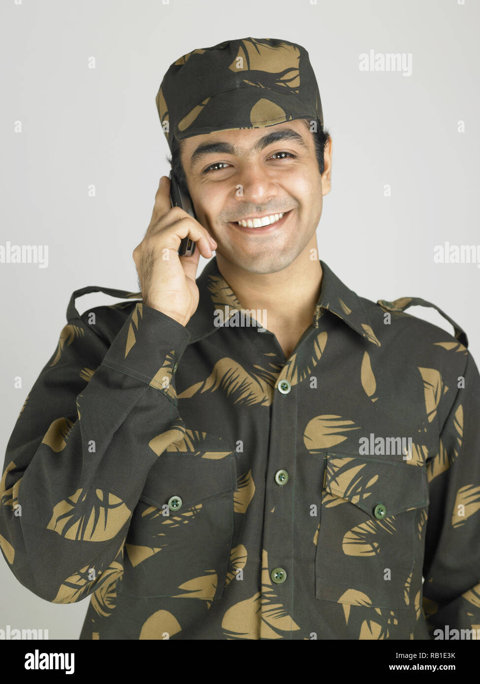 PORTRAIT OF INDIAN SOLDIER DRESSED IN UNIFORM TALKING ON THE MOBILE ...
