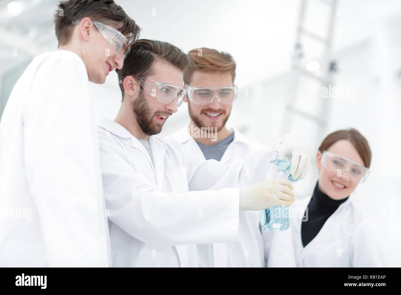 group of scientists working with chemicals Stock Photo - Alamy