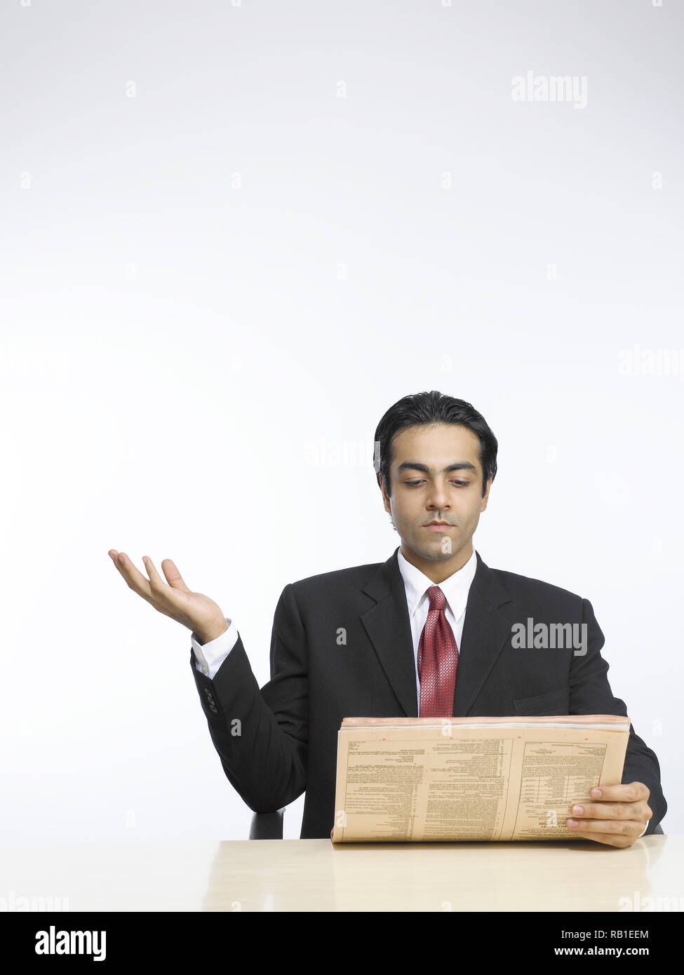 PORTRAIT OF A CORPORATE EXECUTIVE HOLDING OUT A HAND WAITING FOR MONEY ...