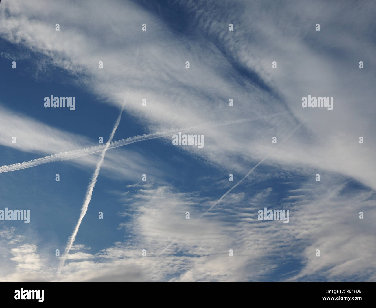 blue sky with plane vapour trails (aka contrails, short for ...