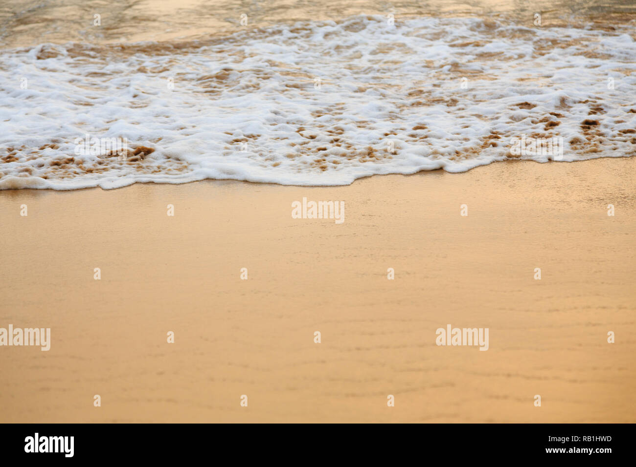 tidal bore, sea bubble foam on sandy beach Stock Photo - Alamy