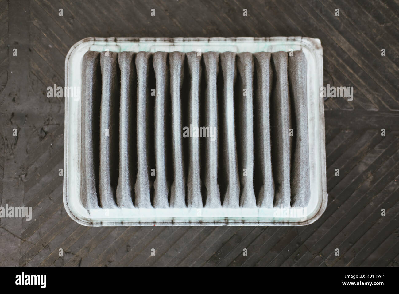 old dirty used air filter from car in automobile repair service garage ...