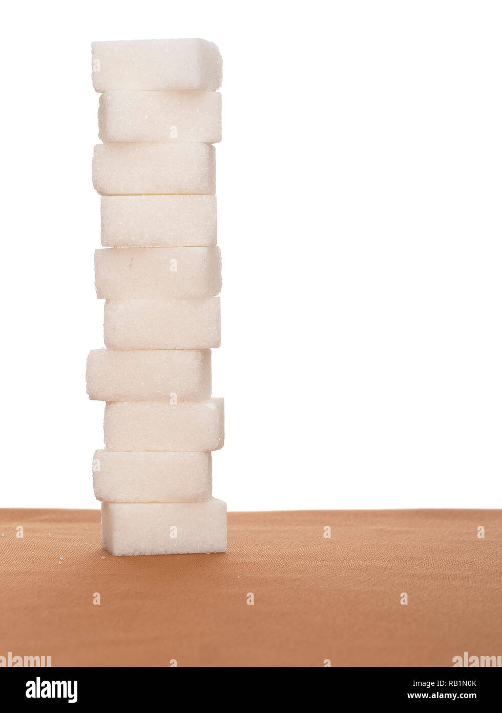 Tall stack of ten sugar cubes on fabric, white background. Healthy ...