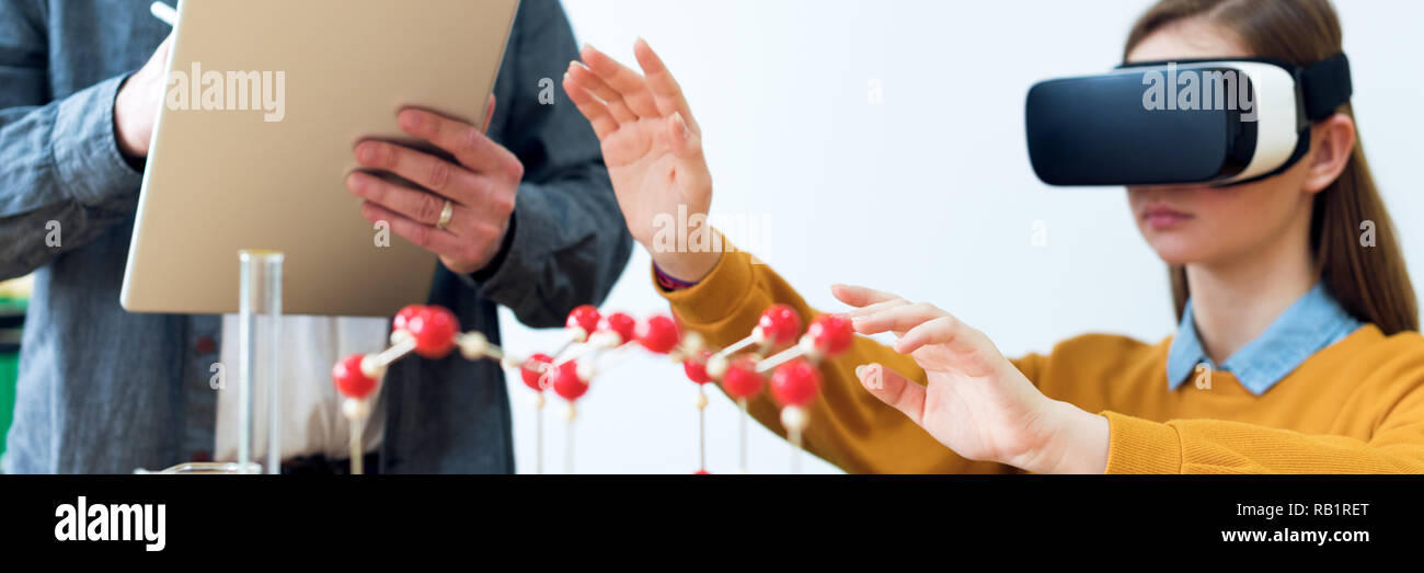 Young teacher using Virtual Reality Glasses and 3D presentation to ...