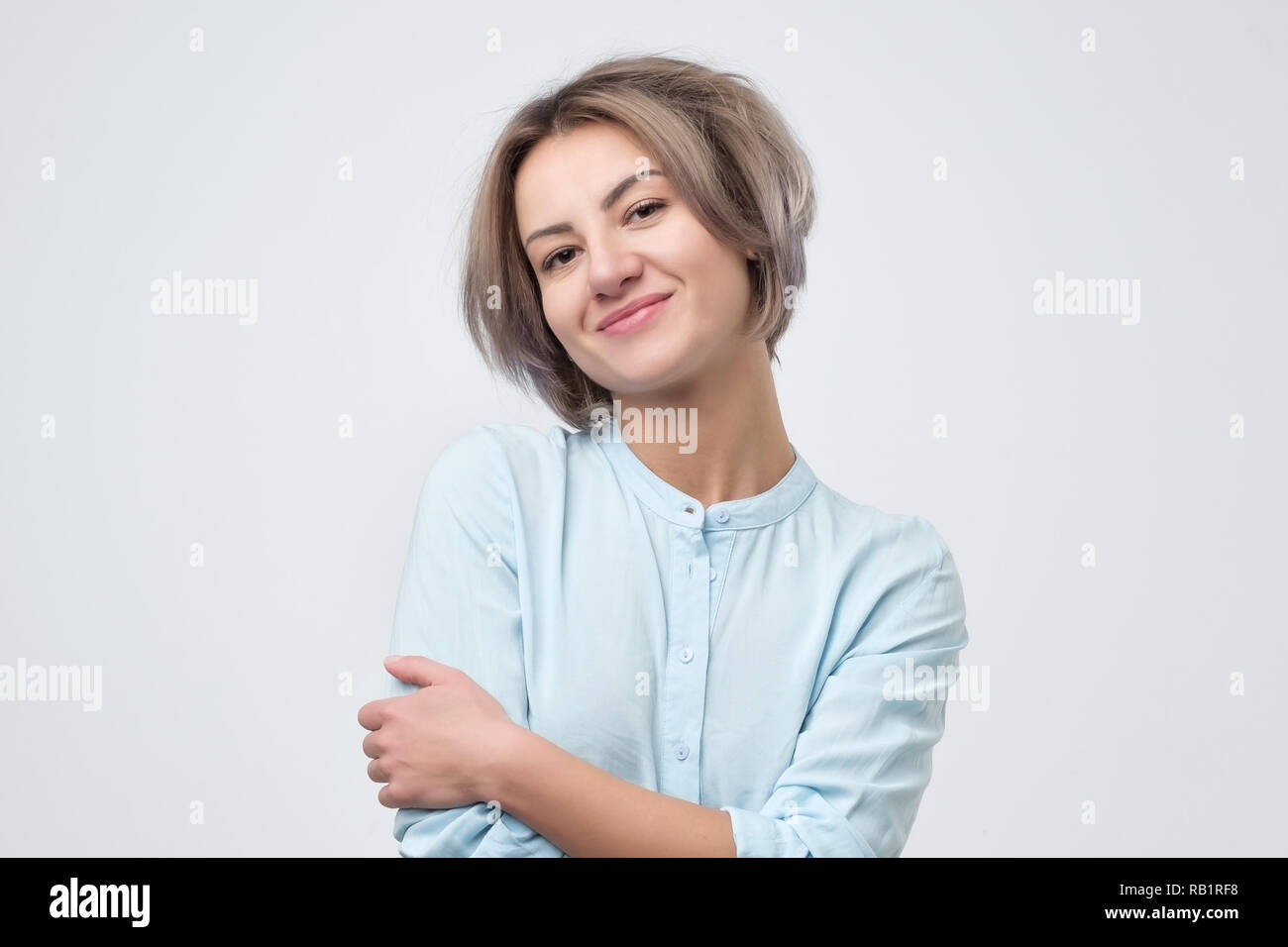 Attractive woman with short fair hair being very glad smiling with ...
