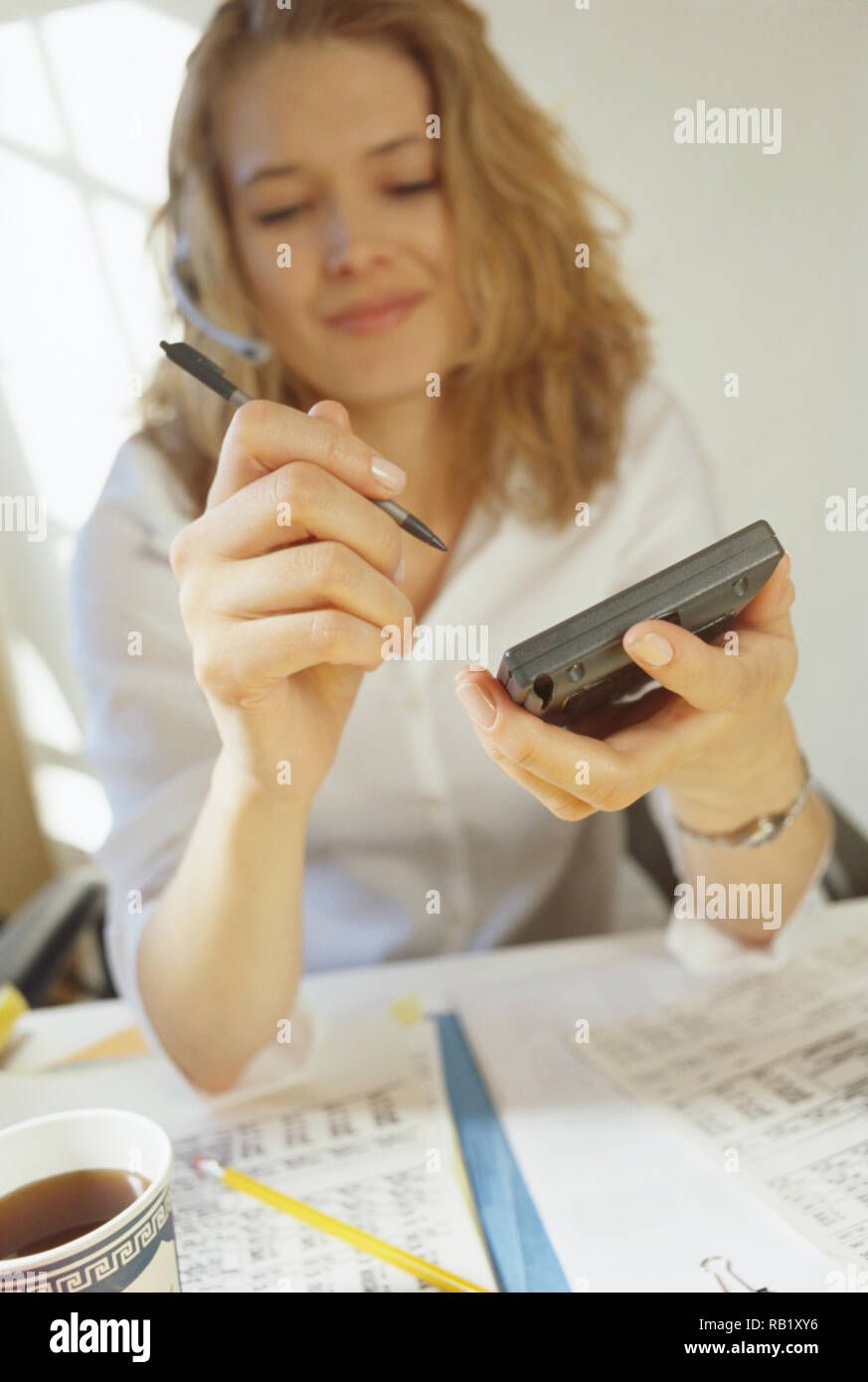 2001 Image of a young businesswoman using a personal digital assistant ...