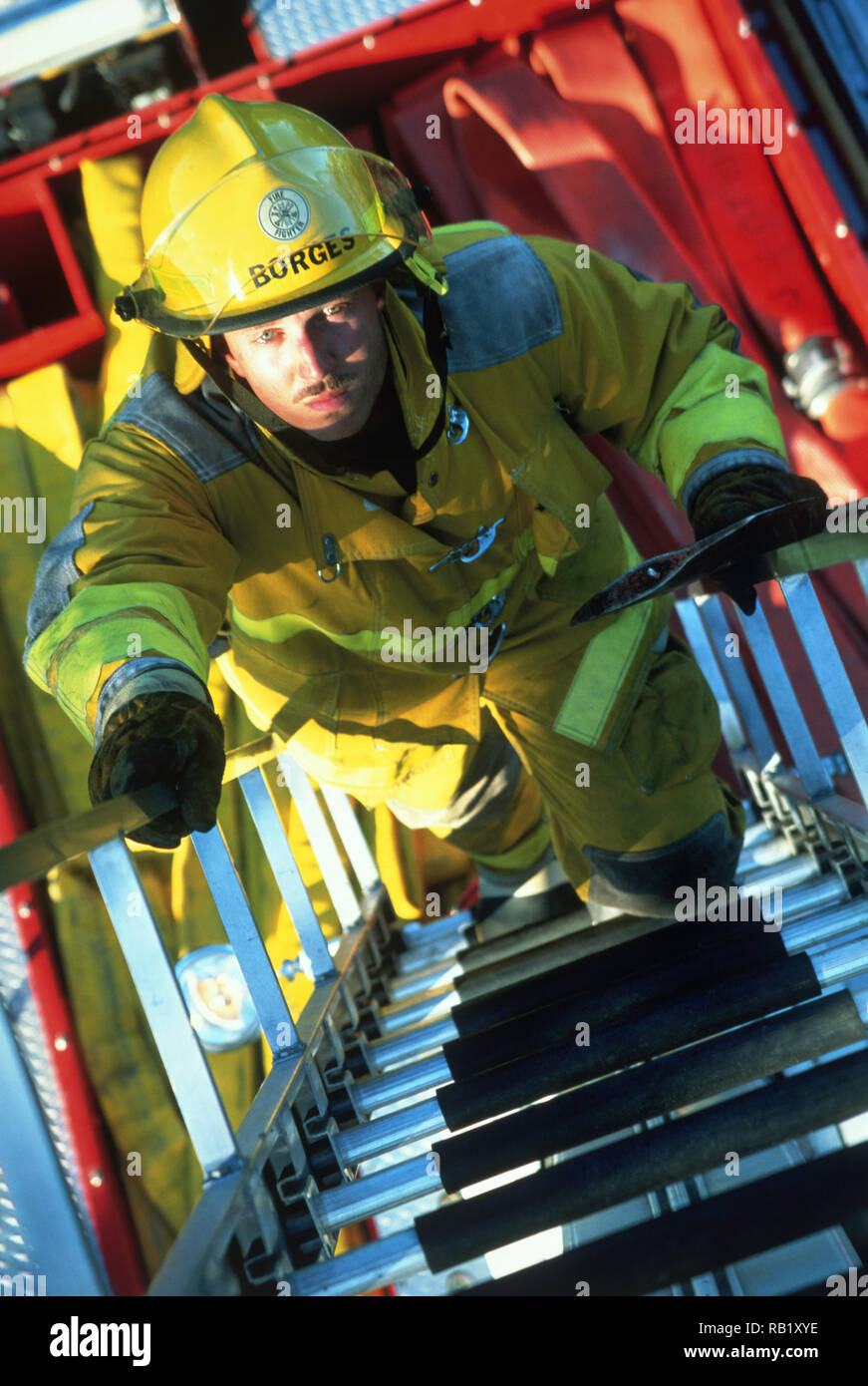 Fireman climbing a ladder hi-res stock photography and images - Alamy