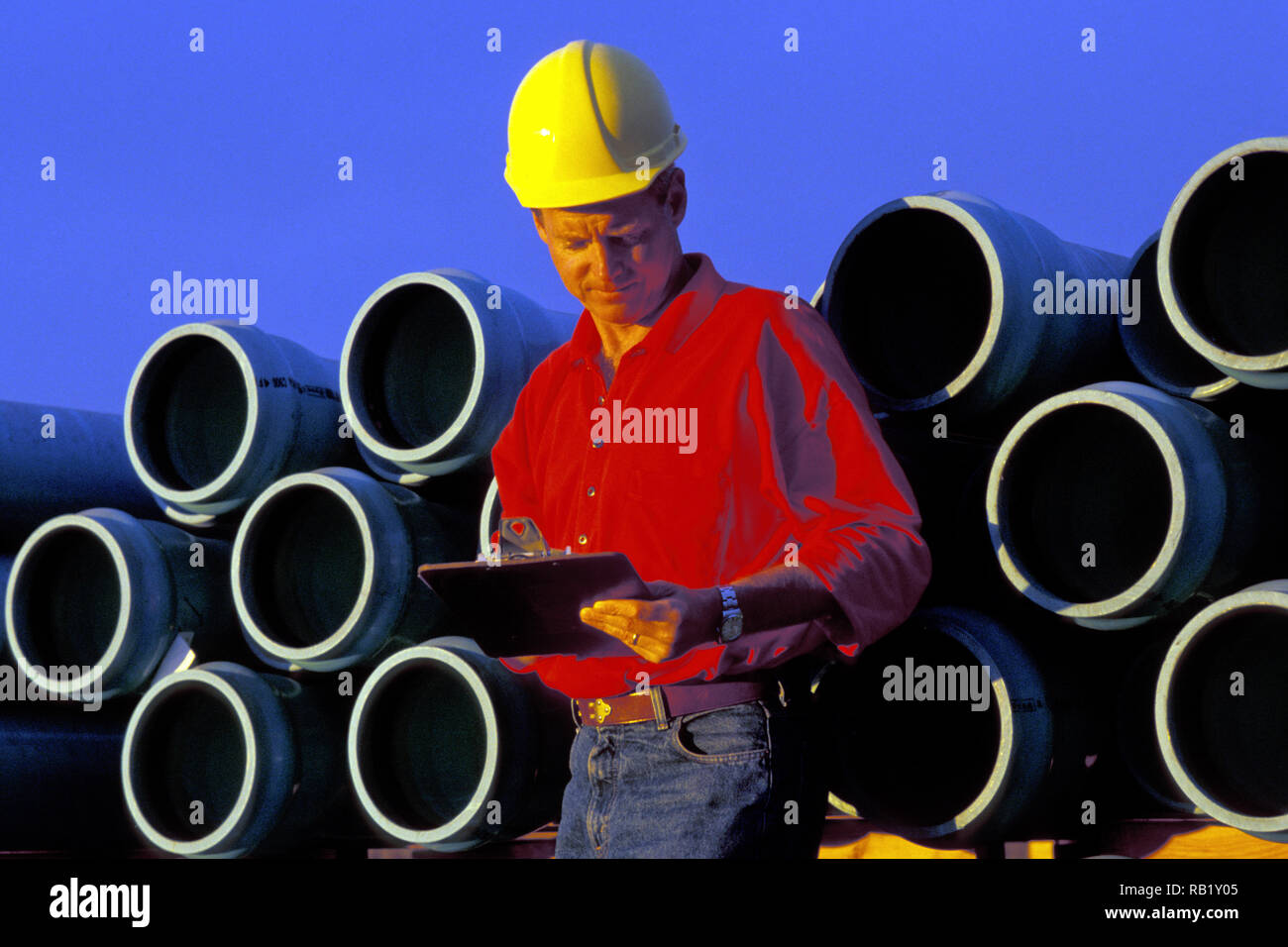 Construction worker leaning on pipes at worksite, USA Stock Photo - Alamy