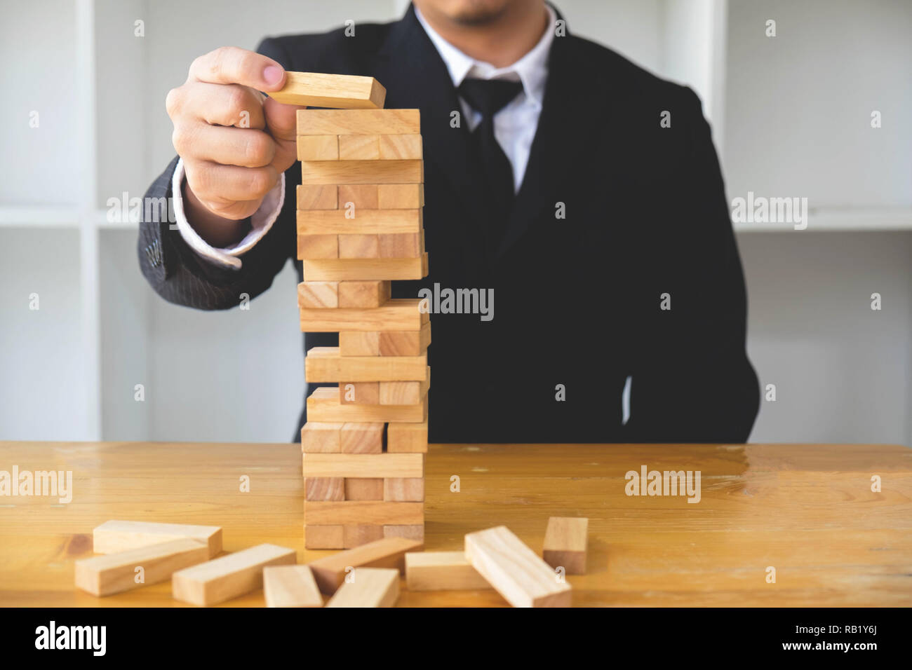 Businessmen picking domino blocks to fill the missing dominos. Growing ...