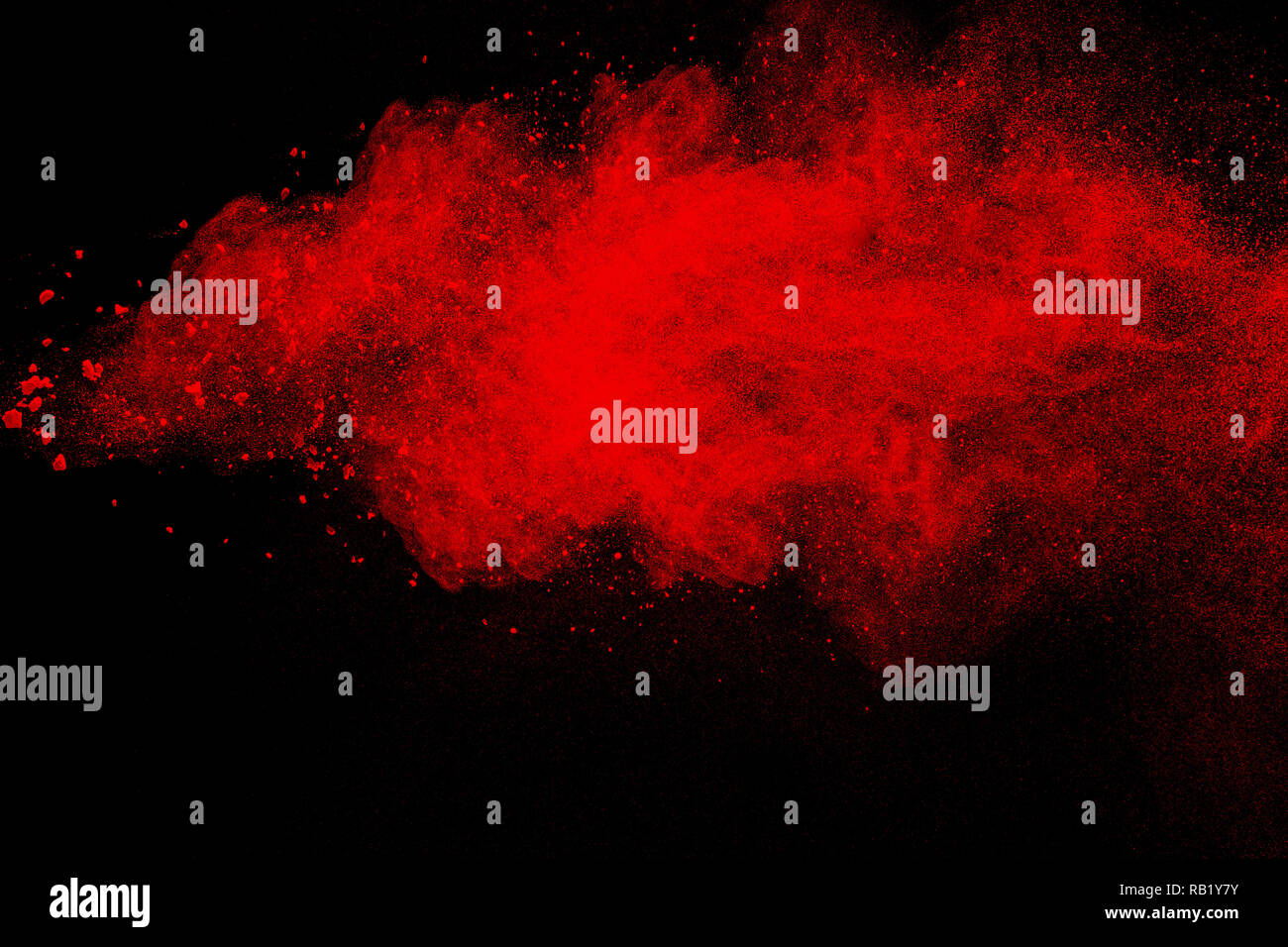 Red color powder explosion on black background.Freeze motion of red ...