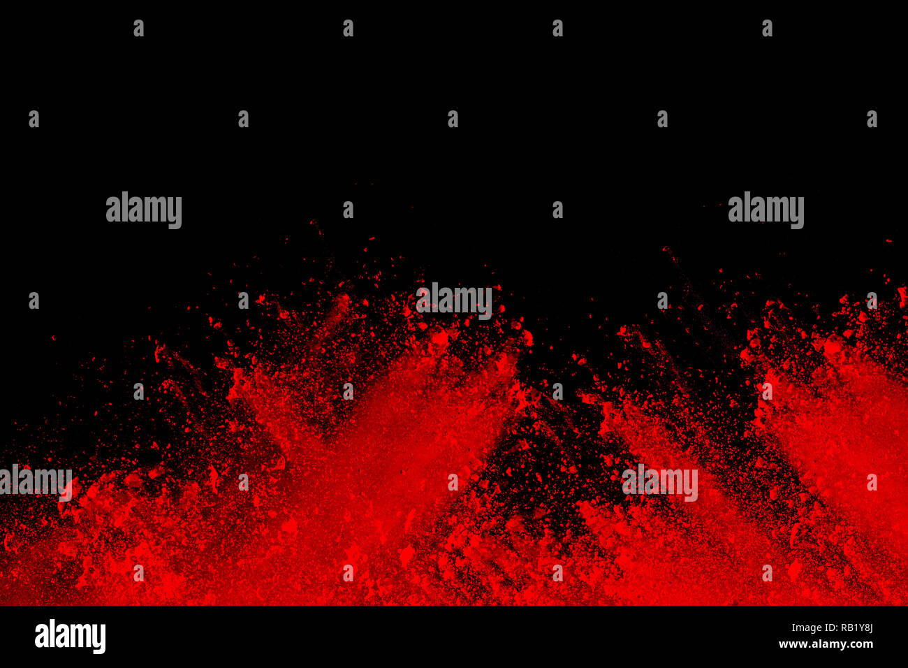 Red color powder explosion on black background.Freeze motion of red ...